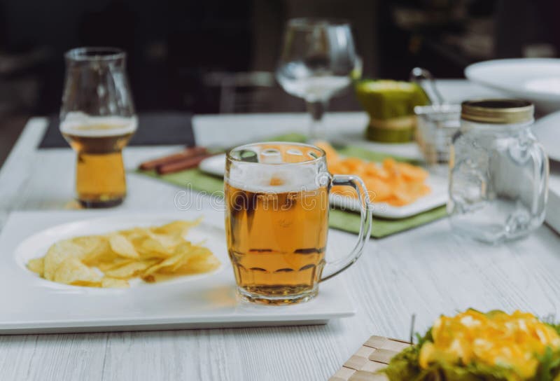 Beer and Chips on the Large White Table Stock Photo - Image of ...