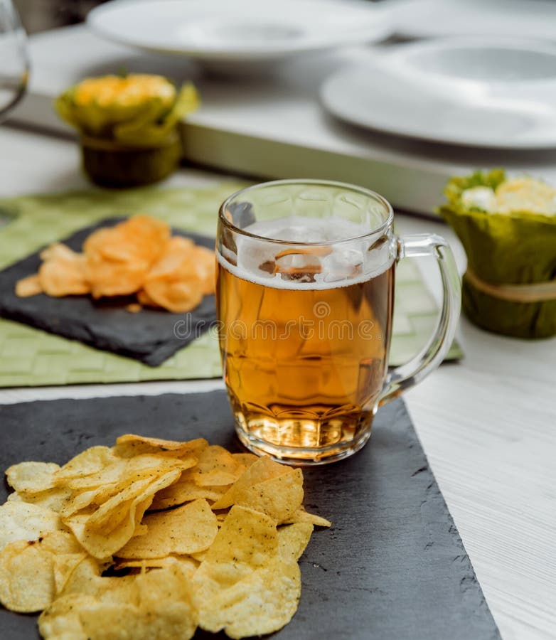 Beer and Chips on the Large White Table Stock Photo - Image of eating ...