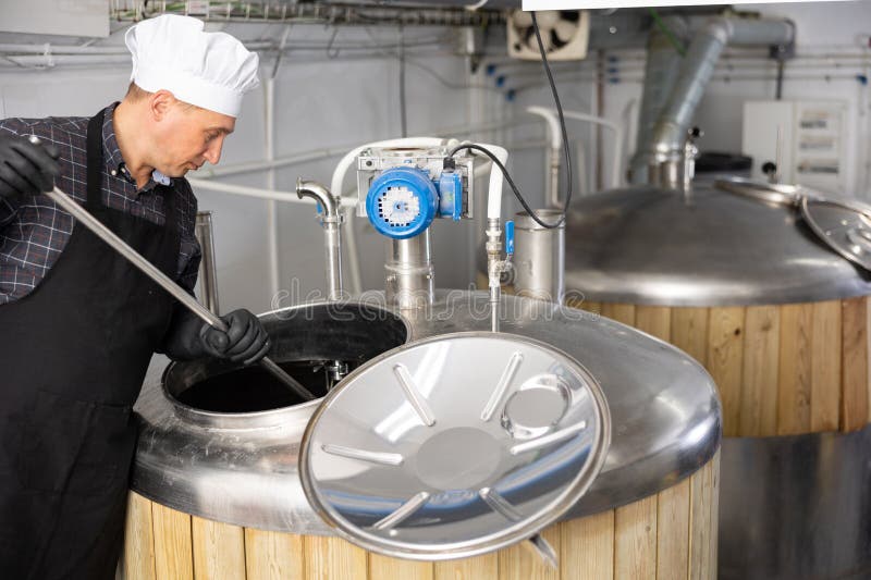 Beer Factory Worker Mixing Beer in Tank Stock Image - Image of looking ...