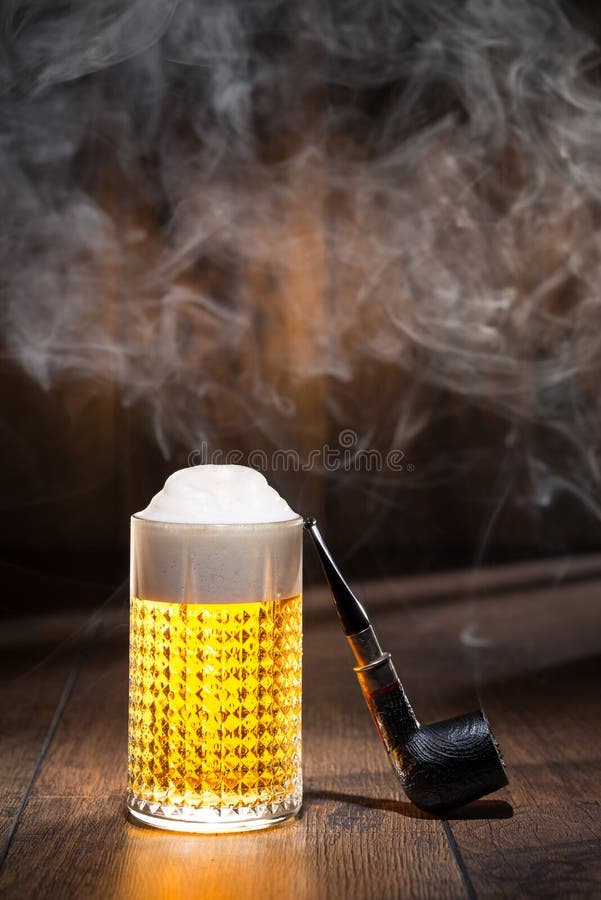 Beer in a glass with pipe stock photo. Image of lager - 73364808