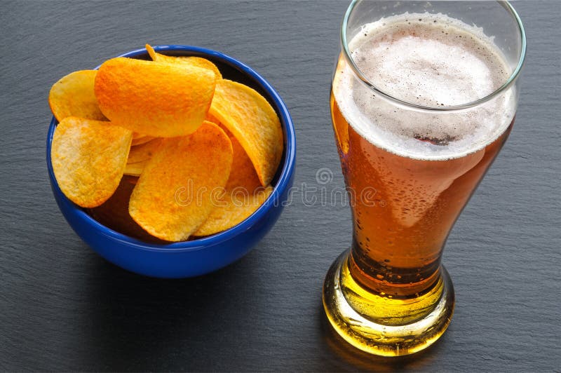 Beer and Many Yellow Saddle Chips Stock Photo - Image of potato, food ...