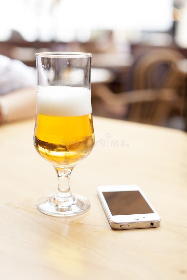 Beer and Mobile Phone on Table Stock Photo - Image of alcohol, phone ...
