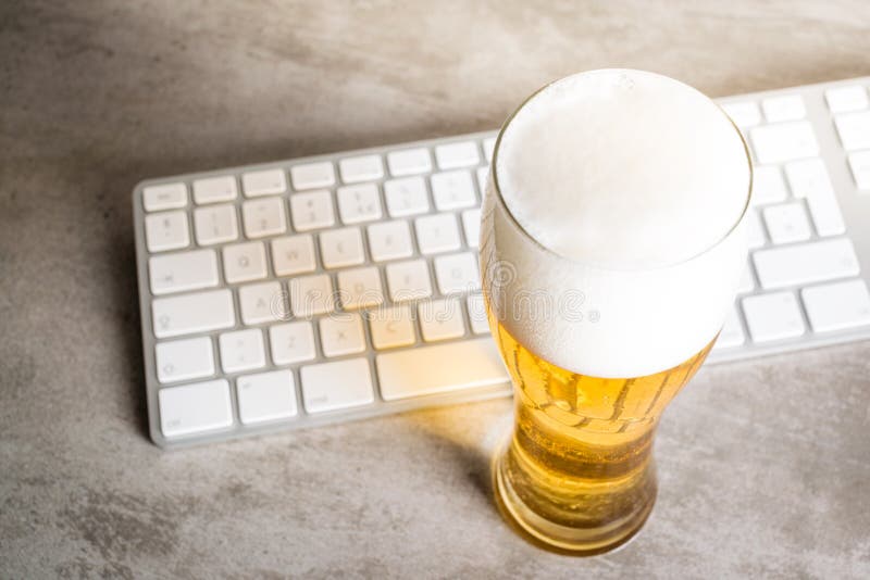 Beer Next To Computer Keyboard on Concrete Table Stock Photo - Image of ...