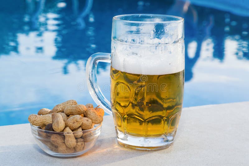 Beer and Peanuts by the Pool Stock Photo - Image of refreshment, froth ...