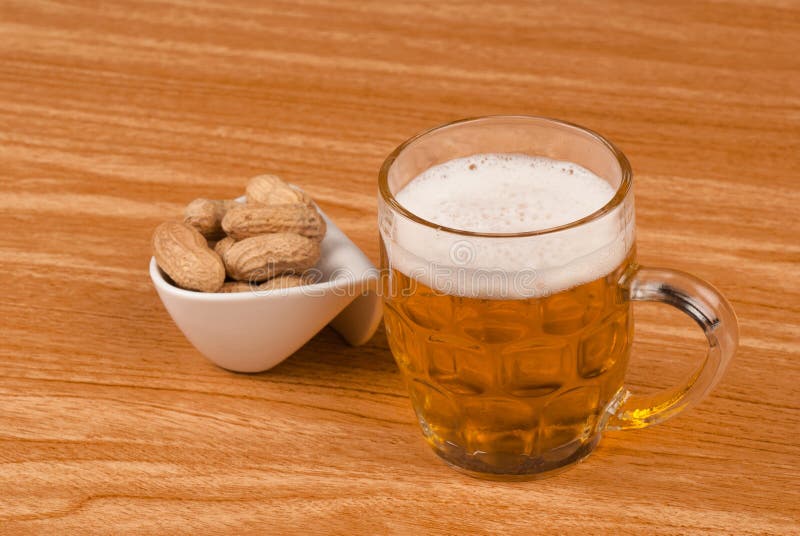 Beer and peanuts on table stock image. Image of assortment - 29743177