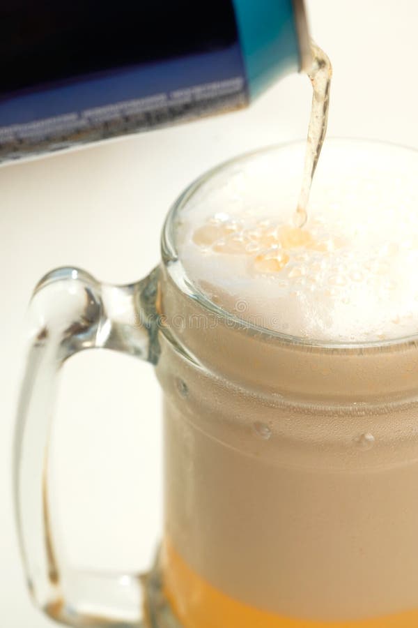 Beer is Poured from a Tin Can into a Transparent Glass Goblet Stock ...