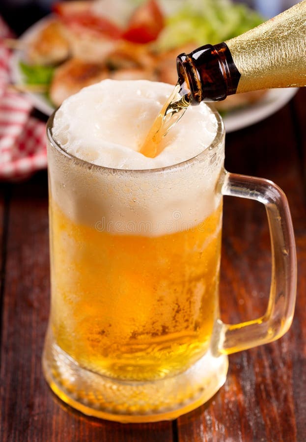 Beer pouring into glass stock photo. Image of foamy, glass - 28063476