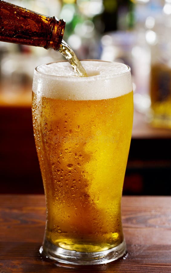 Beer pouring into glass stock photo. Image of lager, condensation ...