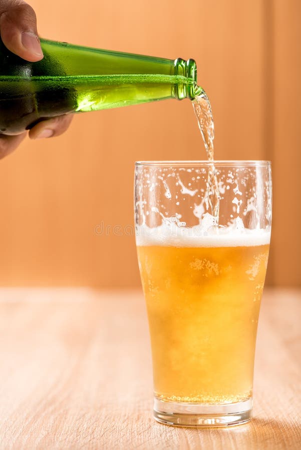 Beer Pouring from Top in Bottle on Wood Table Stock Image - Image of ...