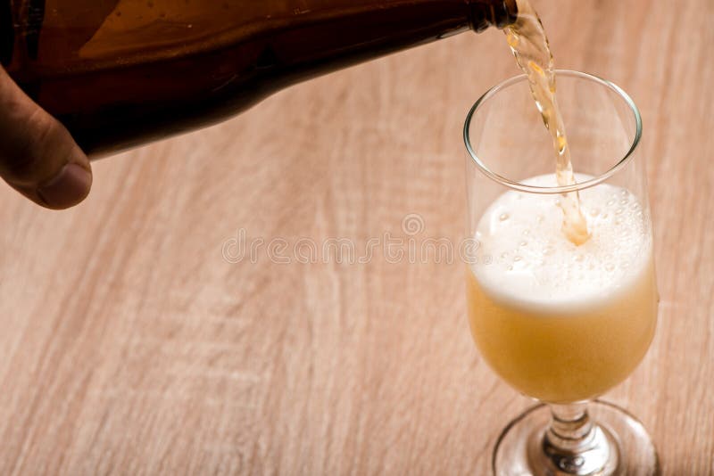 Beer Pouring from Top in Bottle on Wood Table Stock Photo - Image of ...