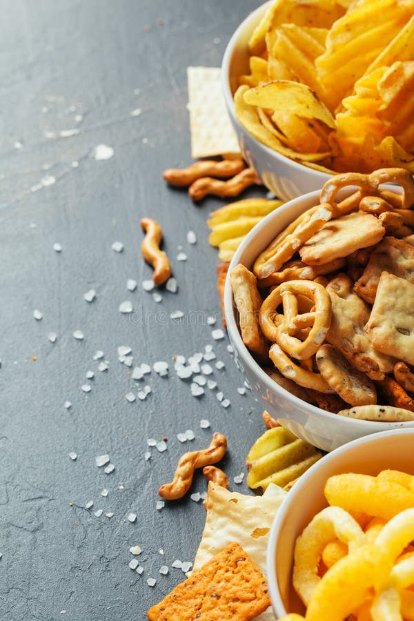 Beer Snacks on Stone Table. Various Crackers, Potato Chips Stock Image ...