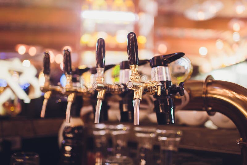 Beer Tap Pours Draught Lager Beer Serving in a Restaurant or Pub. Stock ...