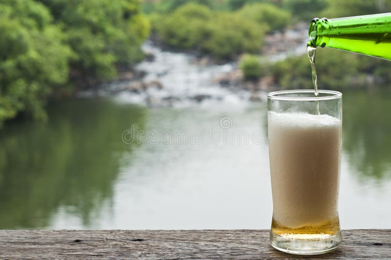 Beer at waterfall. stock photo. Image of green, pouring - 38320250