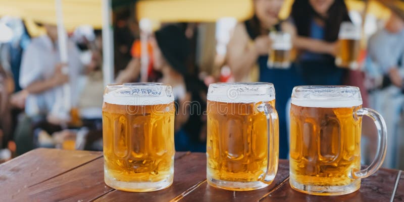 Beers on a wooden table stock photo. Image of foam, beers - 288522646