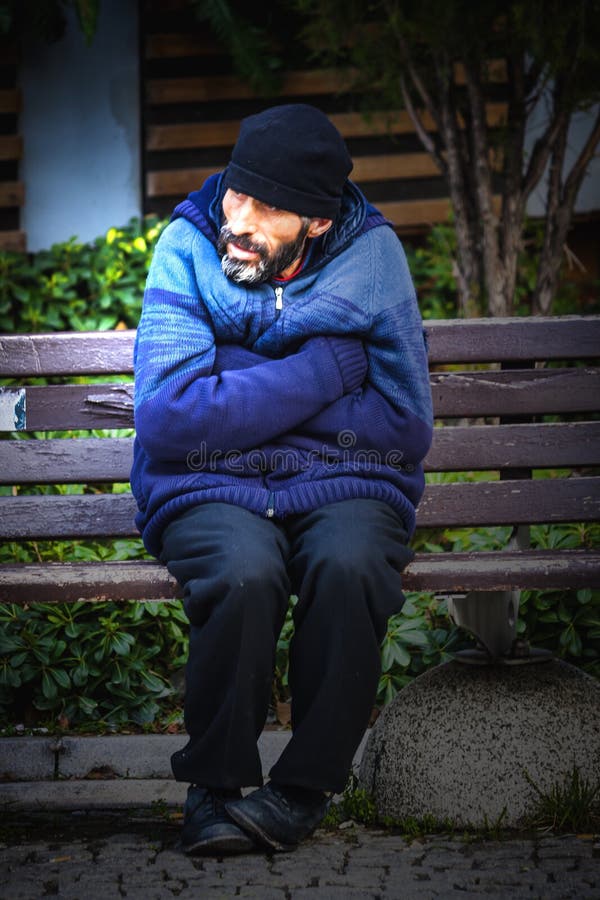 Beggar man on a bench editorial image. Image of cold - 85562080