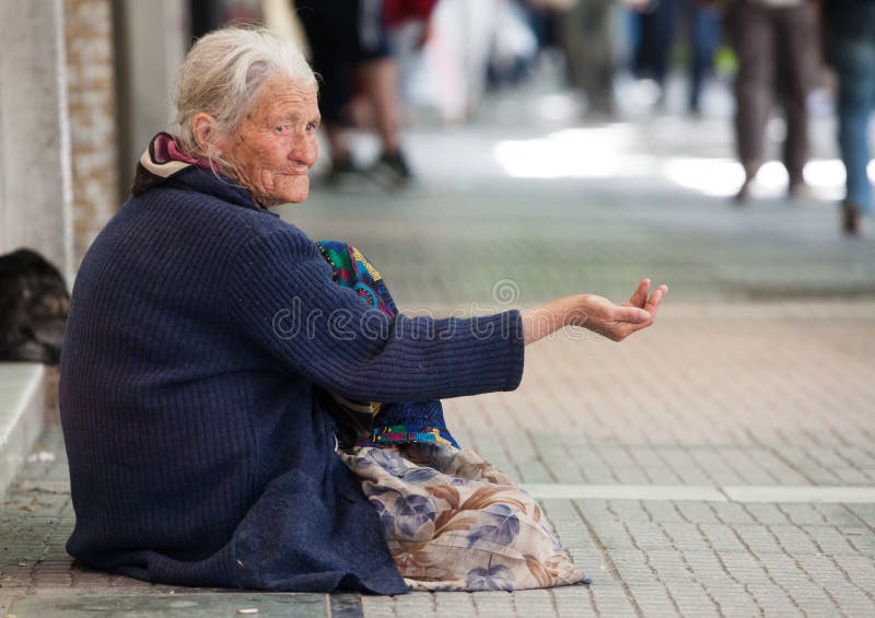 Unrecognizable Woman Giving Food To Homeless Beggar Man Sitting In City