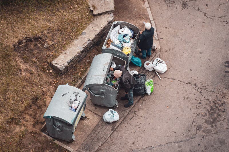 Beggars Man and Woman Looking for Food in the Trash Can Stock Image ...