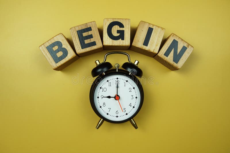 Begin Word and Alarm Clock Top View on Yellow Background Stock Photo ...