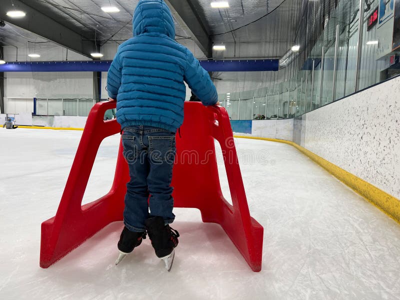 Beginner Ice Skater Using a Plastic Walker for Assistance. Stock Photo ...