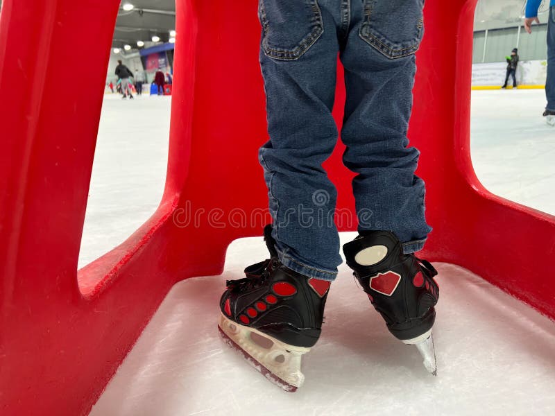 Beginner Ice Skater Using a Plastic Walker for Assistance. Stock Photo ...