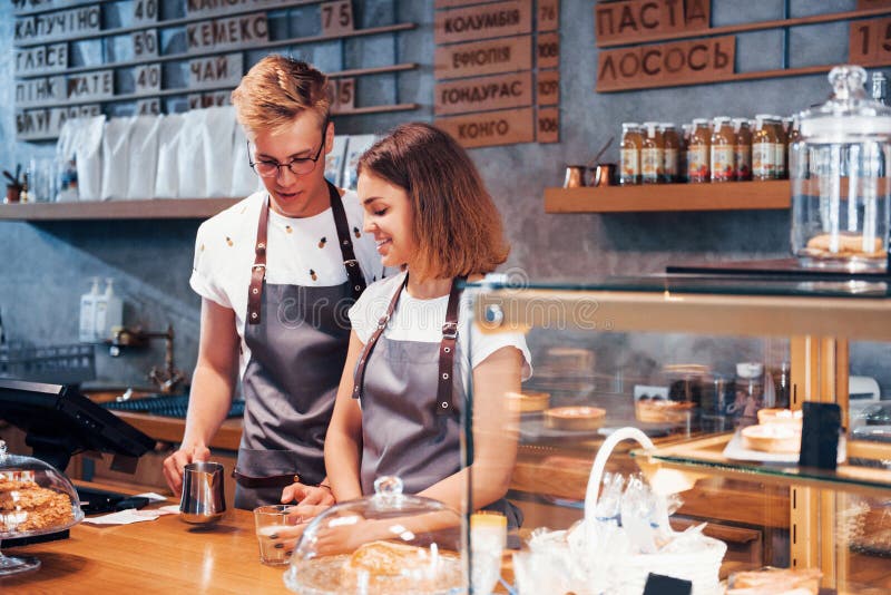 Behind the Bar. Two Young Cafe Workers Indoors Stock Image - Image of ...