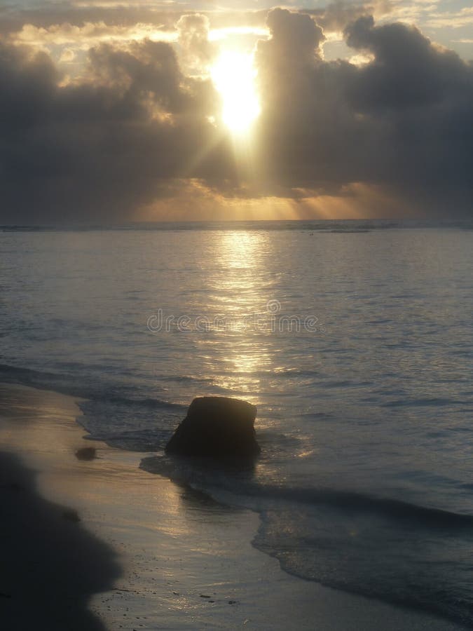Behind the Clouds the Setting Sun is Reflected in the Sea Stock Image ...