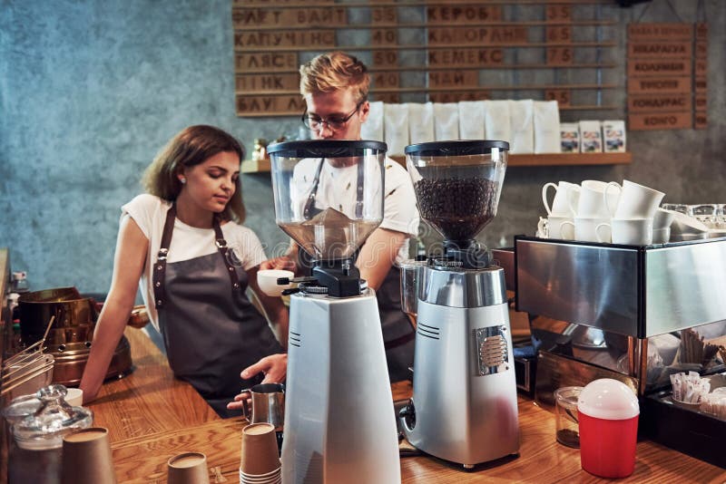 Behind the Coffee Machine. Two Young Workers Indoors Stock Image ...