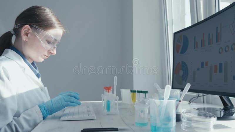 Behind a Computer Screen, Laboratory Technician Enters Data To Study ...