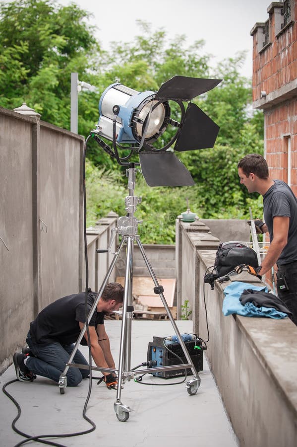Behind the Scene. Filmmaking Lighting Technician Adjusting and Setup ...