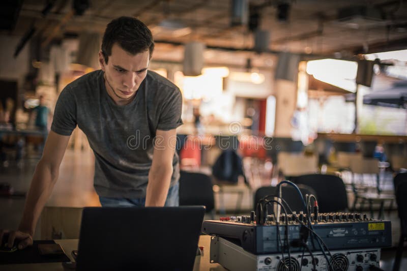 Sound Technician at Theatre Adjusting Sound Elements, Looking at Script ...