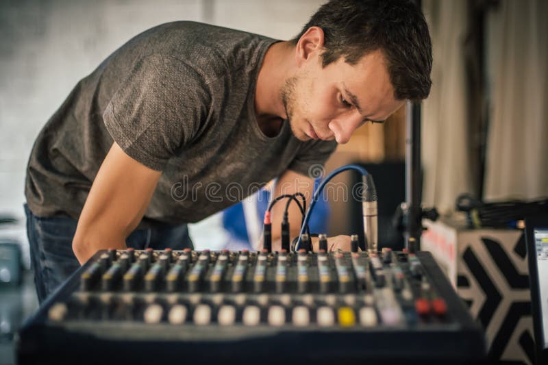 Sound Technician at Theatre Adjusting Sound Elements, Looking at Script ...