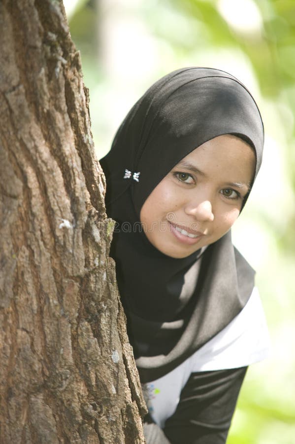 Behind the tree stock image. Image of moslem, bark, smile - 10122715