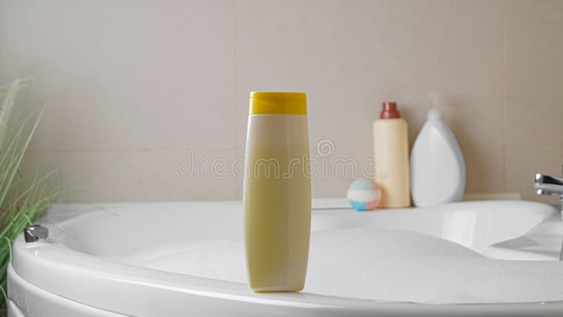 Beige Bottle of Bubble Bath on Tub Indoors Stock Photo - Image of ...