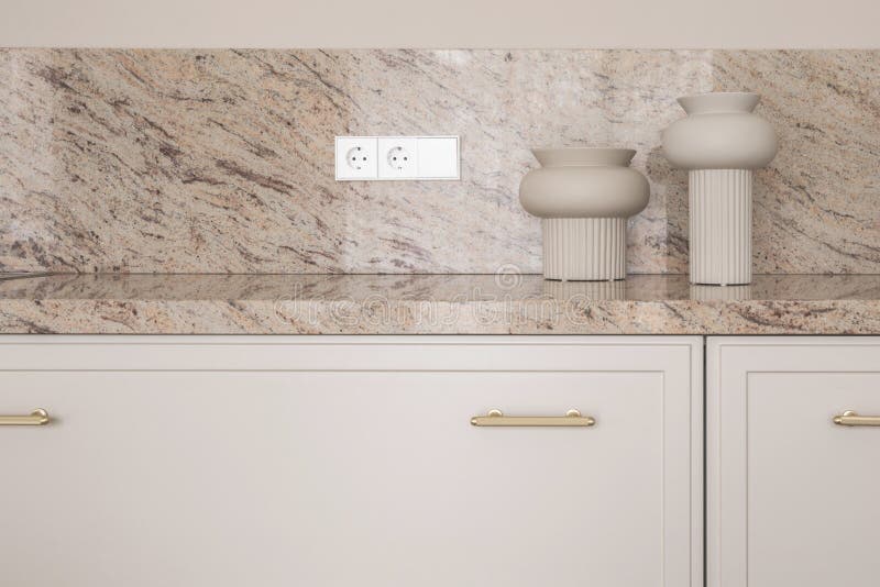 Beige Granite Kitchen Counter with Electric Outlets on Stone Wall, Two ...