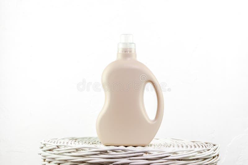 Beige Laundry Detergent Bottle Standing on Wicker Surface Against White ...
