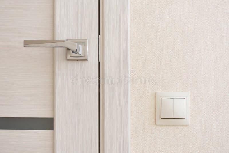 Beige Light Switch Installed Next To the Door on the Wall Stock Photo ...