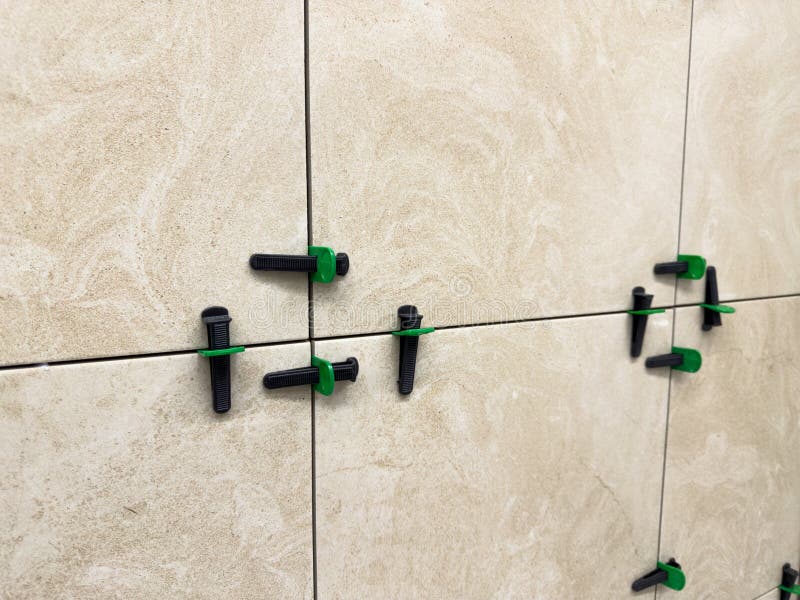 Beige Marble Style Ceramic Tiles Installed with Leveling System. Close Up Shows Neat Grout Lines ...