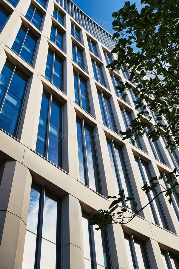 Beige Office Building with Windows and Tree Branches Stock Image ...