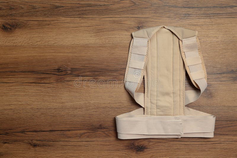 Beige Posture Corrector on Wooden Table, Top View. Space for Text Stock ...