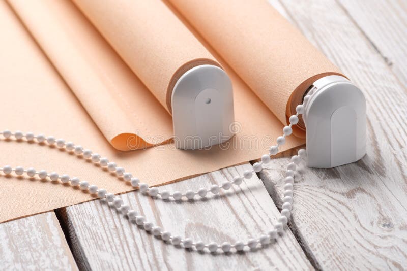 The Beige Rolled Blind is on a White Wooden Surface. Stock Photo ...