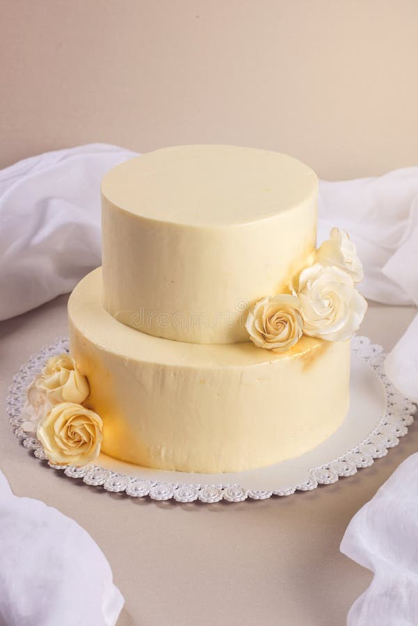 Beige 2 Tiered Wedding Cake Decorated with Mastic Roses Stands on ...