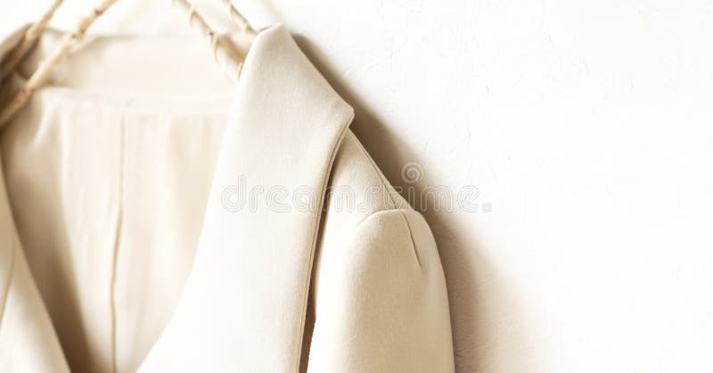 The Jacket is Hanging on the Back of the Chair in the Room Stock Photo ...