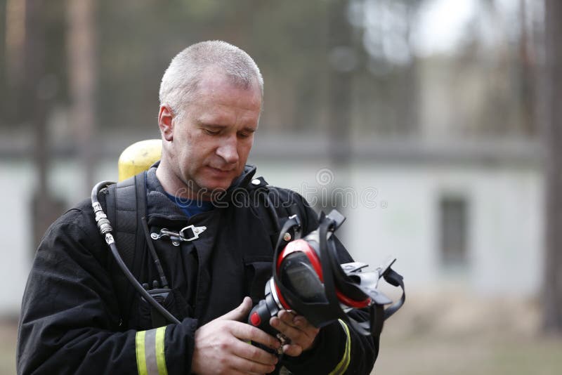 Firefighter and rescuer editorial photography. Image of danger - 106035132