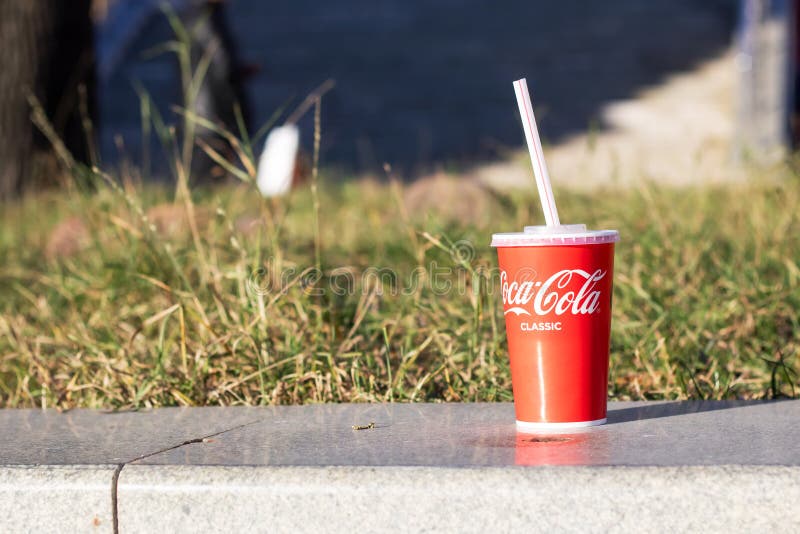 Belarus, Minsk - 29 October, 2023: Glass of Coca Cola on Curb by Grass ...