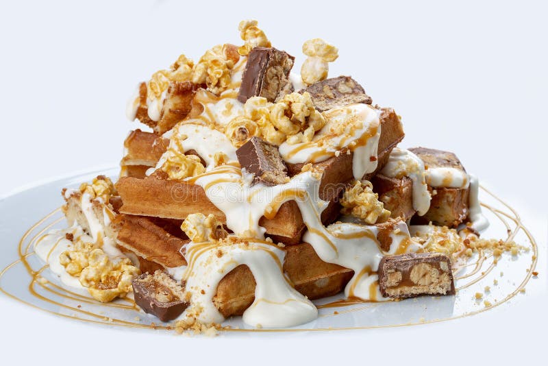 Belgian Waffles with Caramel Topping, Chocolate Bars and Popcorn Stock ...