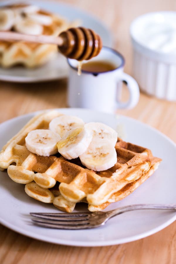 Belgian waffles and tea stock photo. Image of bananas - 185485446