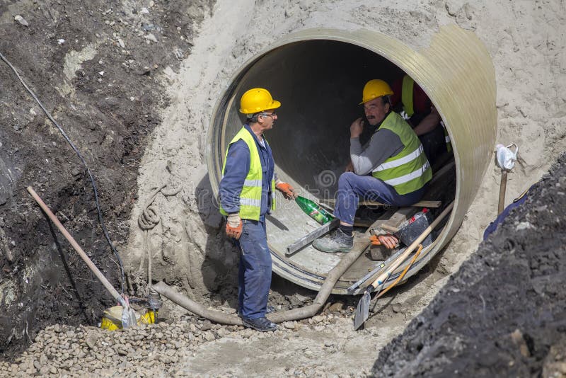 Construction Workers Resting in Big Pipe Editorial Photography - Image ...