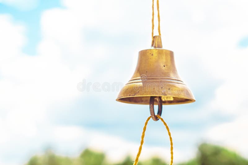 The bell hangs on a rope stock photo. Image of golden - 134215252