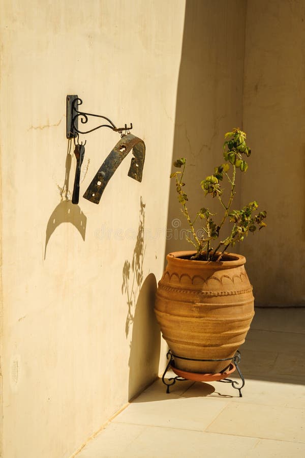 Bell on the Wall and Flower Pot Stock Photo - Image of sunset, door ...