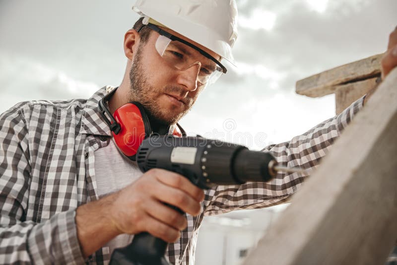 Male Builder Using Driver during Work Stock Photo - Image of overcast ...